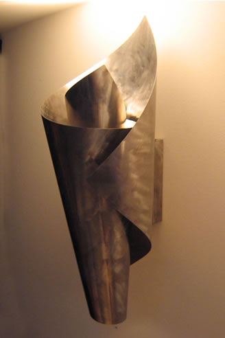 This stainless steel wall lighting adds subtle beauty to a room while ...